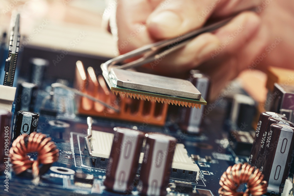 Engineer plug in CPU microprocessor to motherboard socket Stock Photo ...