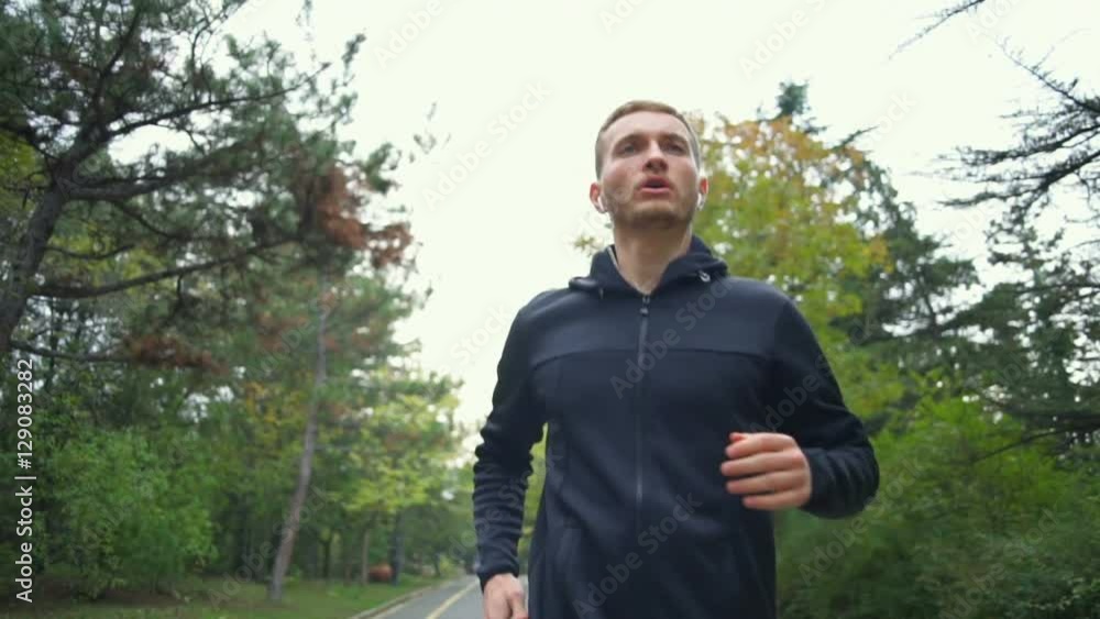 Young handsome man jogging in the street slow motion Stock Video ...