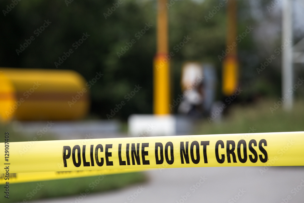 police line do no cross with gas station background in crime scene ...