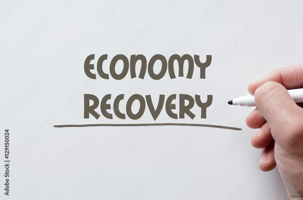 Economy recovery written on whiteboard Photos | Adobe Stock