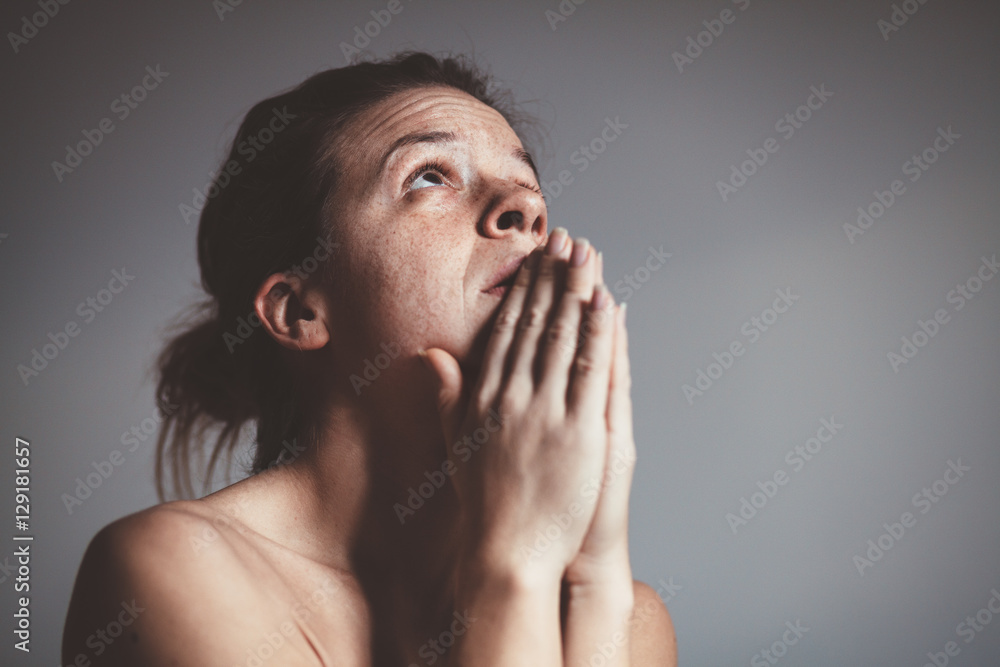 Young woman sad and praying Stock Photo | Adobe Stock