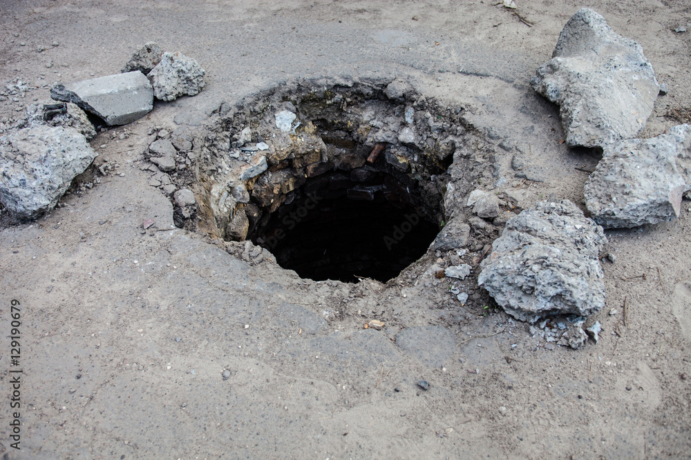 Broken manhole without cover in asphalt surface Stock Photo | Adobe Stock