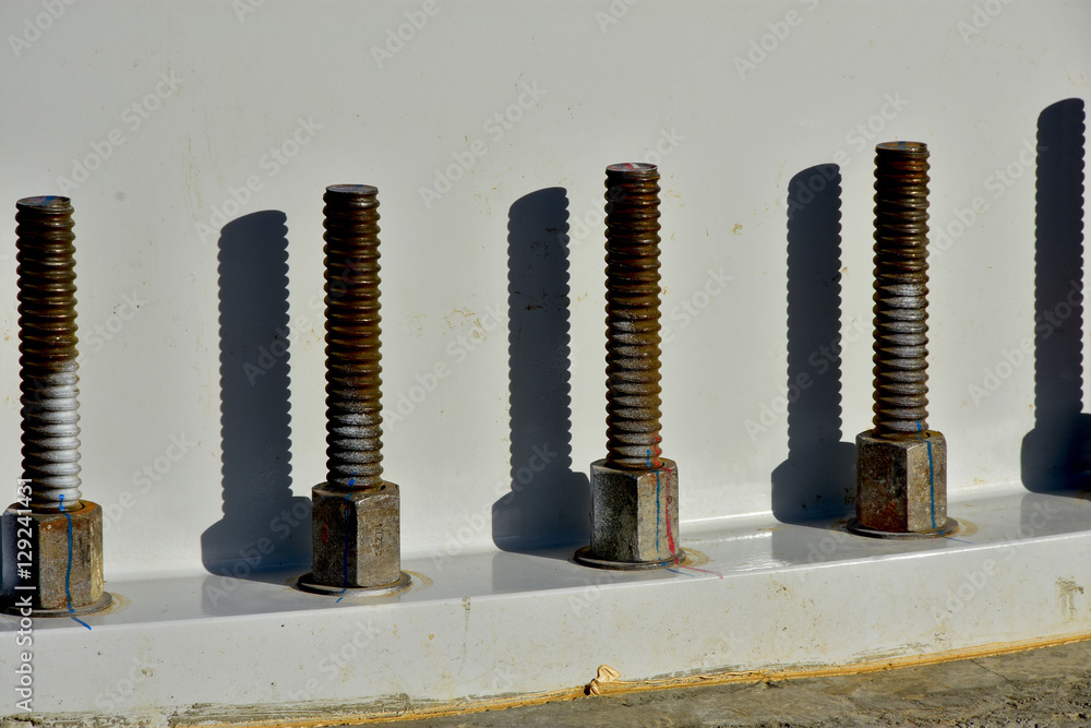 base section of turbine tower, concrete foundation and large bolts ...