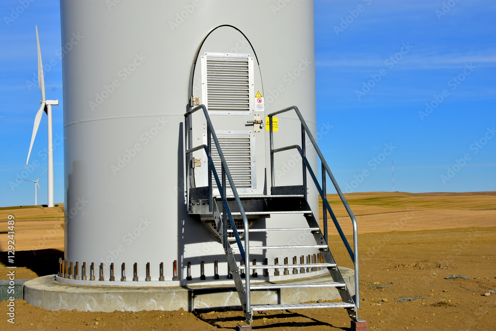 base section of turbine tower, concrete foundation and large bolts ...