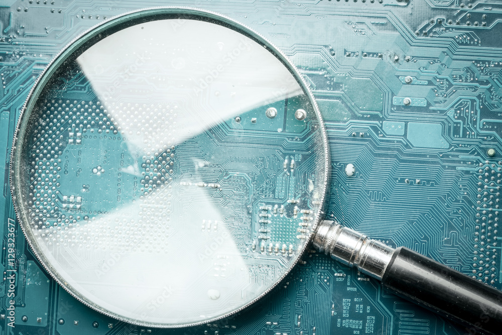 magnifier on a computer circuit board, with copy space for your ...