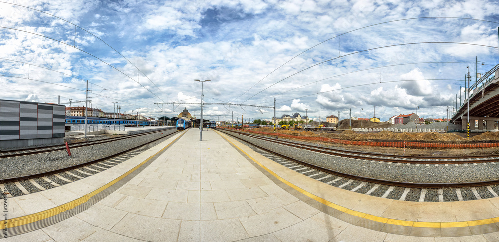 Perspective shot of a platform between two railway tracks going in ...