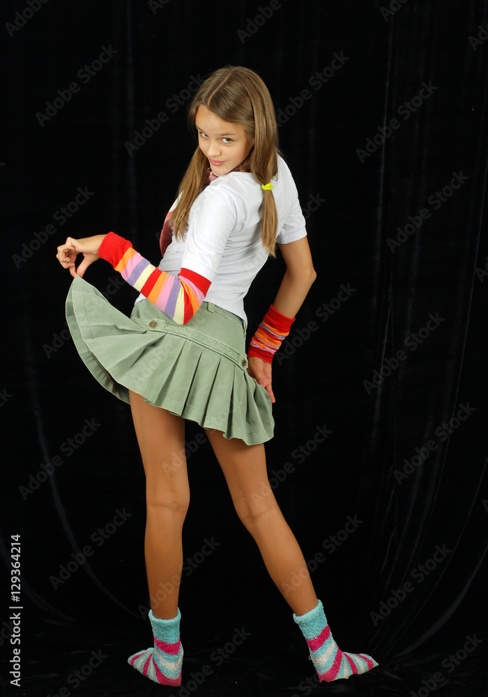 mischievous girl in a short skirt Stock Photo | Adobe Stock