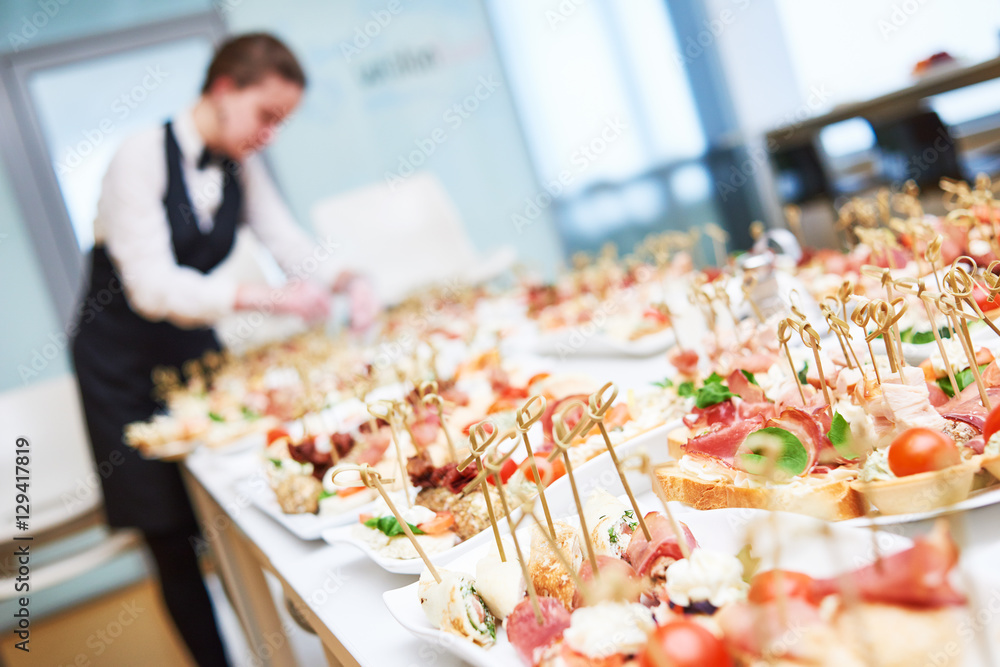 Catering. Restaurant waitress serving table with food Stock Photo ...