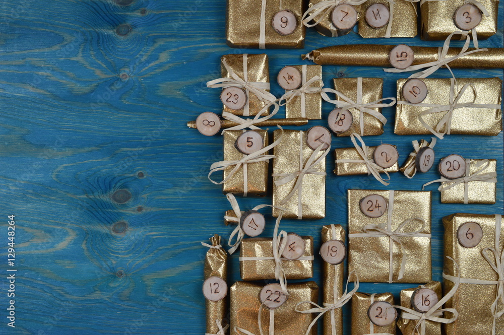 Border of advent calendar with twenty four golden presents on teal wood ...