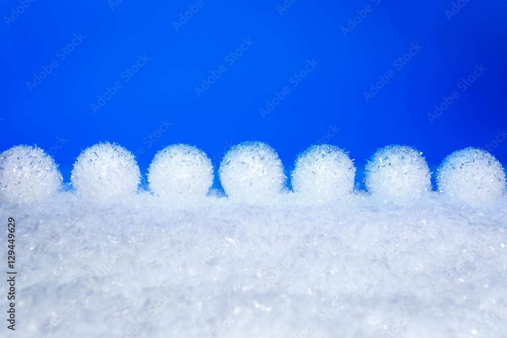 Christmas seven snowballs lie in the line on snow in the blue ...
