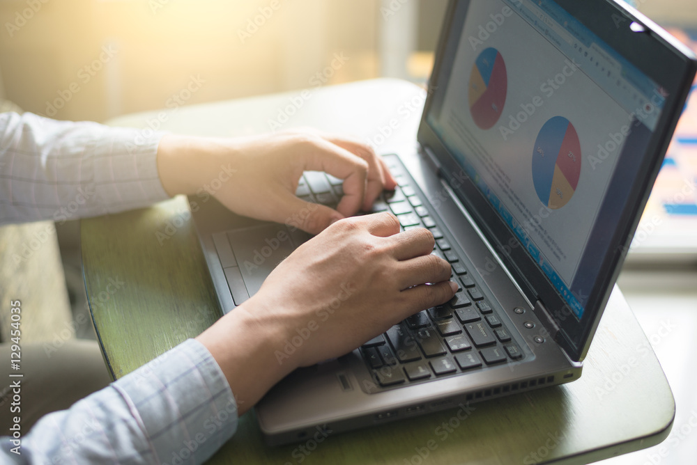 Two Hands man typing keyboard of laptop on small table, monitor screen ...