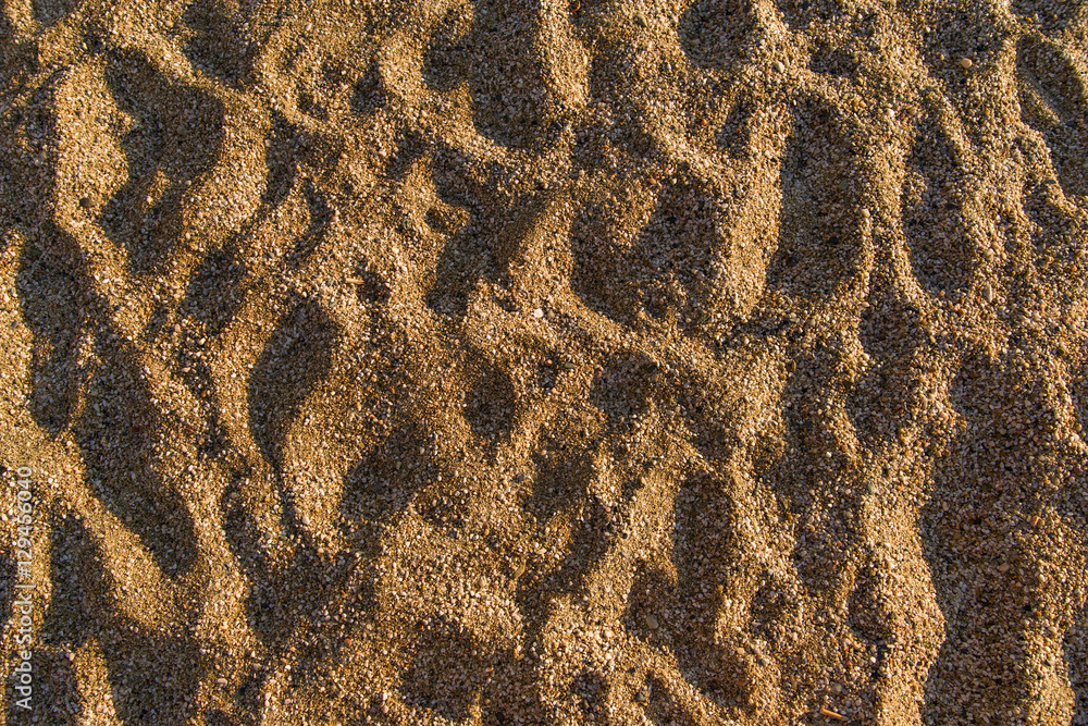 Sand texture. Uneven surface. Sandy beach for background. Hard shadows ...