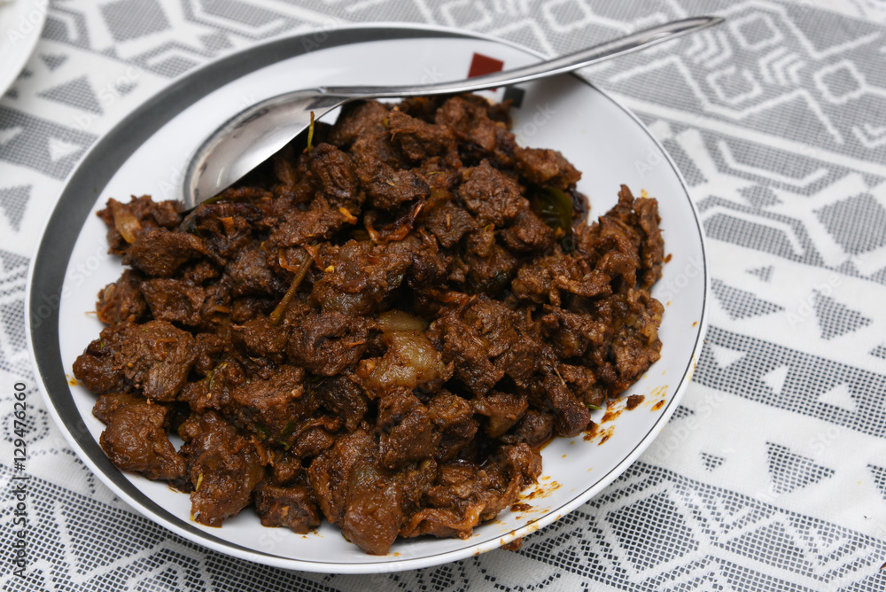 Spicy red beef fry curry and brown rice South Indian dish Kerala, India ...