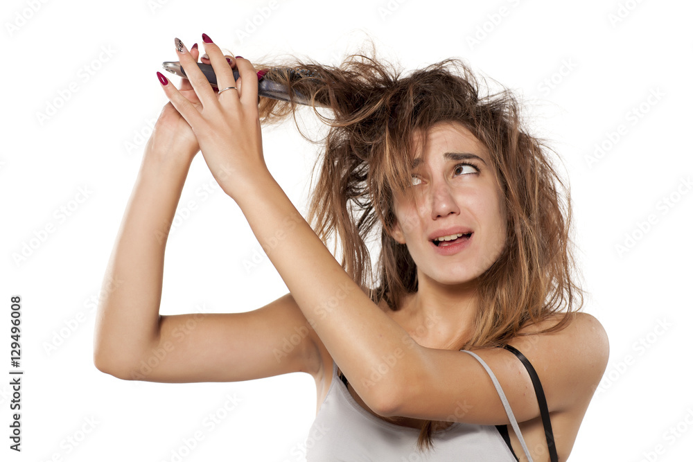 nervous young woman with brush stuck in her messy hair Stock Photo ...