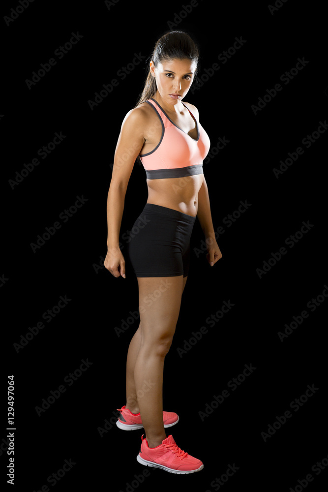 latin sport woman posing in fierce and badass face expression with fit ...
