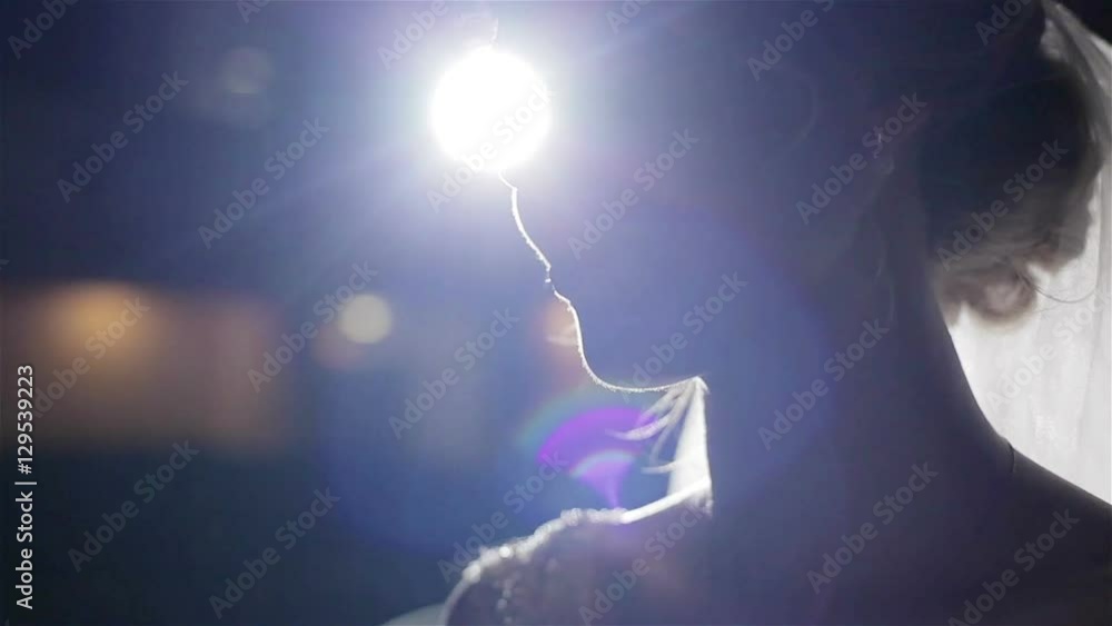 Young woman face backlight silhouette close up extra in dark background ...