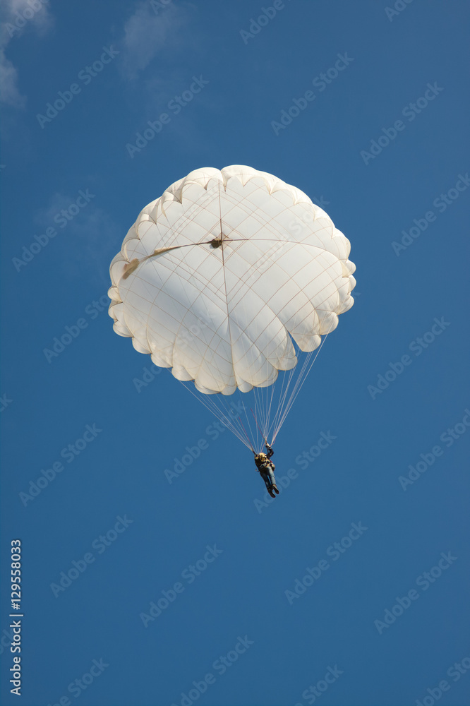White round parachute on background blue sky. Stock Photo | Adobe Stock
