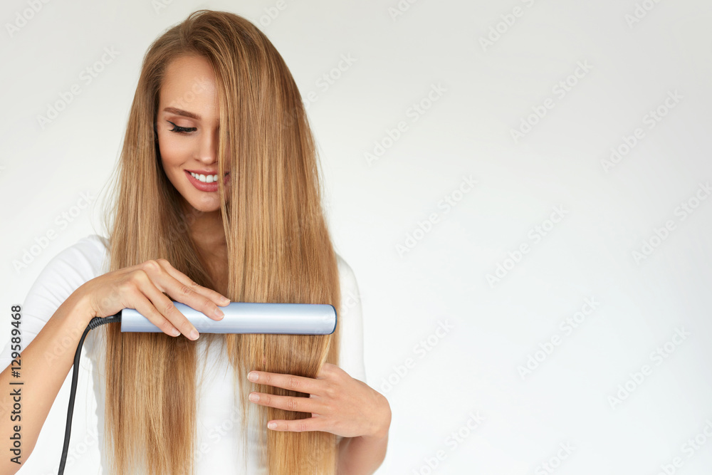 Hairdressing. Woman With Beautiful Long Hair Using Straightener Stock ...