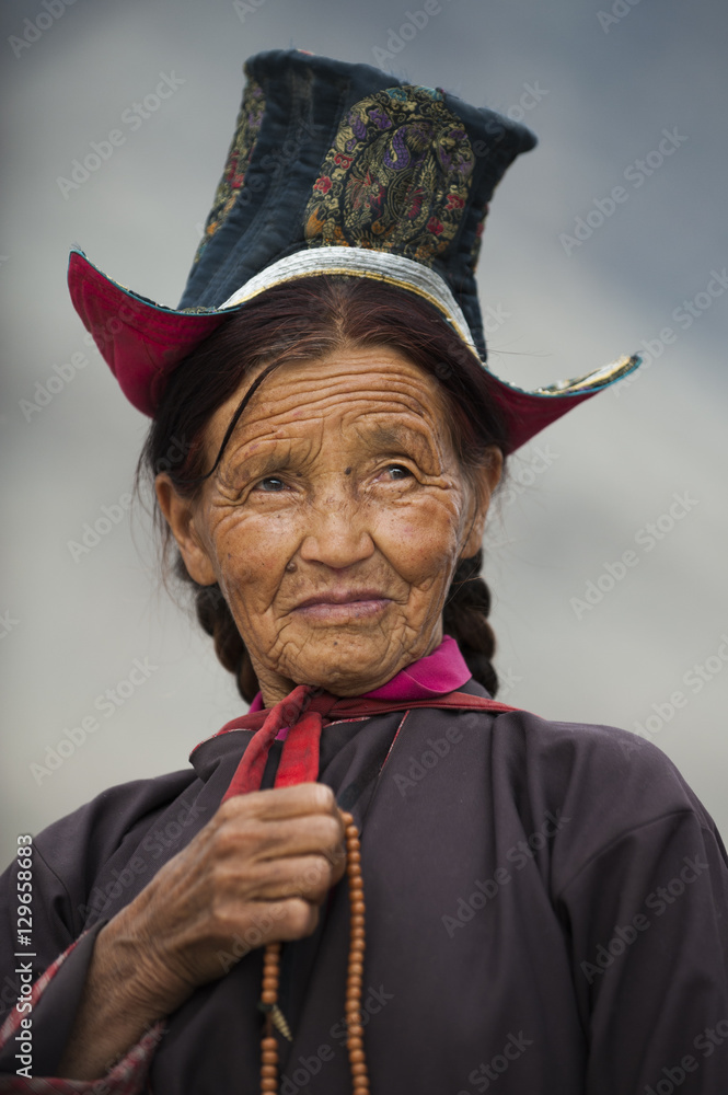 Buddhist woman travelling to a festival at the 14th-century Diskit ...