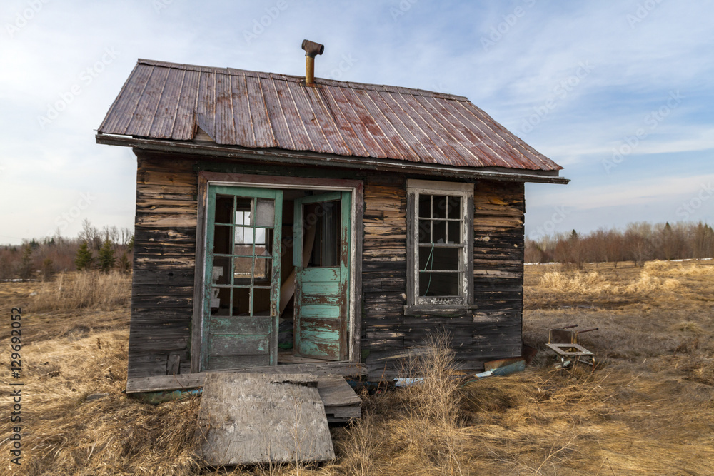 neglected cabin in a farmer field Stock Photo | Adobe Stock