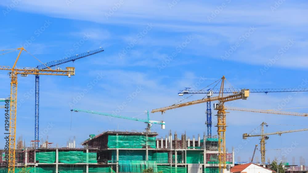4k Time-lapse of Industrial construction crane with blue sky background ...