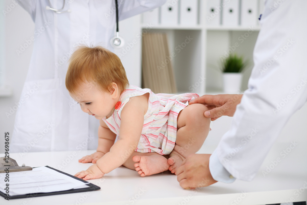 Happy cute baby after health exam at doctor's office. Medicine and ...