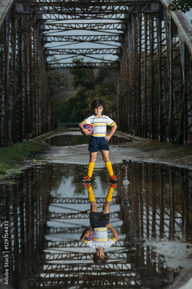 Boy rugby player posing with ball and trophy Stock Photo | Adobe Stock