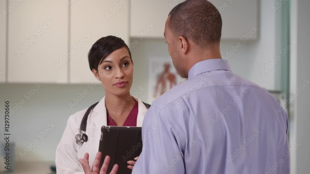 An African American doctor advises her patient. A black medical ...