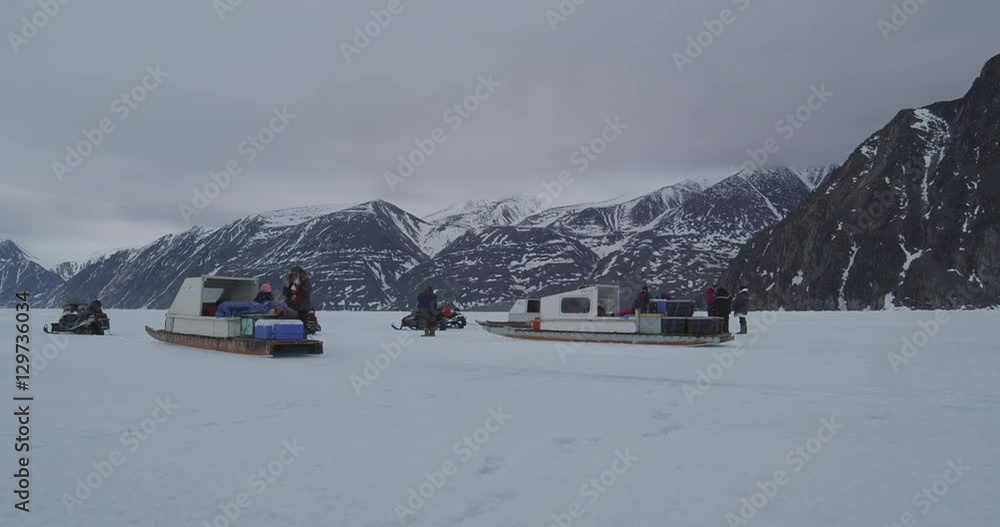 Skidoos Komatiks and Tourists on sea ice with Mountains Stock Video ...