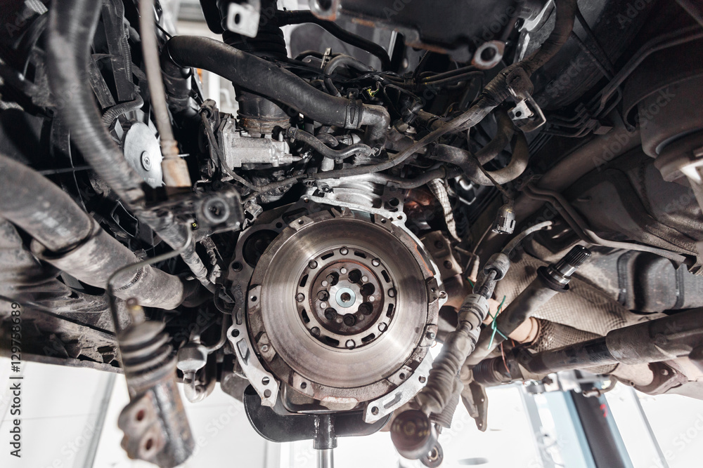 Change and repair clutch, drive axle. working underneath a lifted car ...