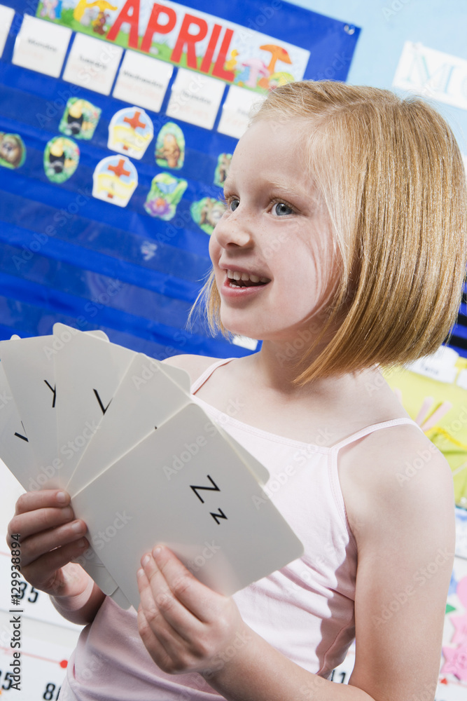 Elementary student with alphabet flash cards in classroom Stock Photo ...