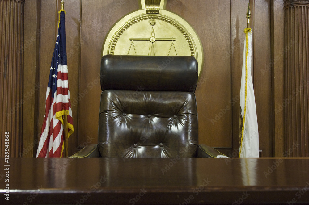 Judge's chair and flags in courtroom Stock Photo | Adobe Stock