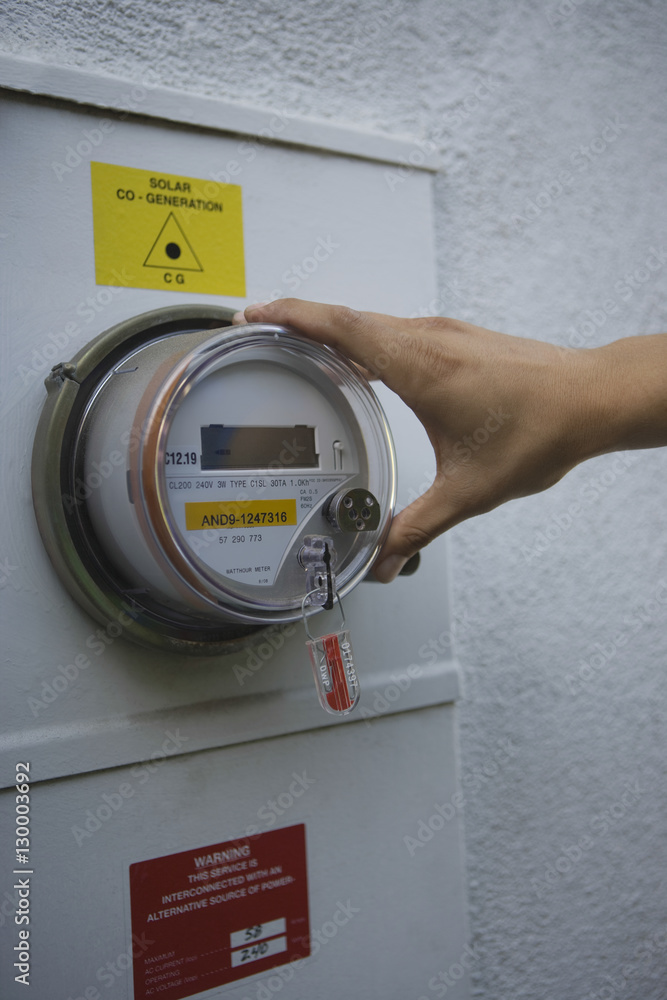 Hand on meter of solar generation unit in Los Angeles, California Stock ...