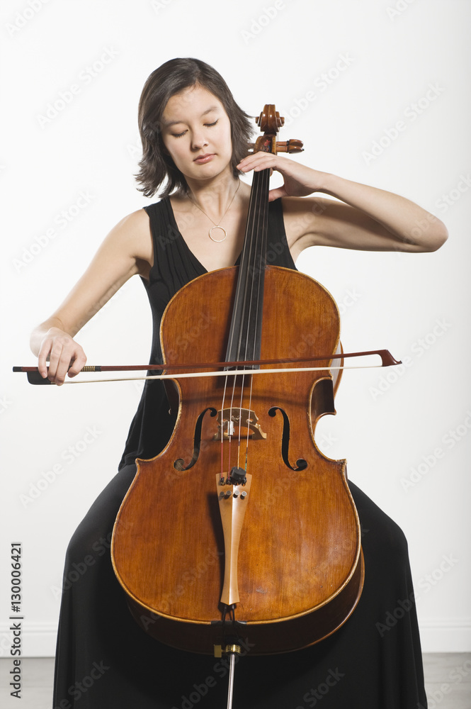 Foto de Beautiful young woman playing cello classical music instrument ...