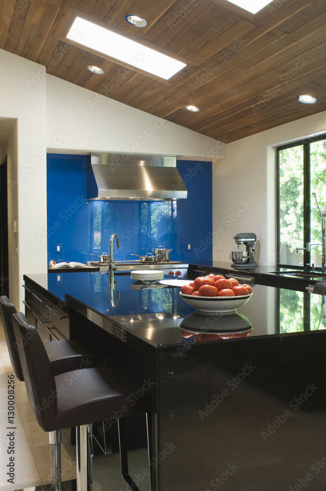 Blue backsplash and breakfast bar in modern kitchen Stock Photo | Adobe ...