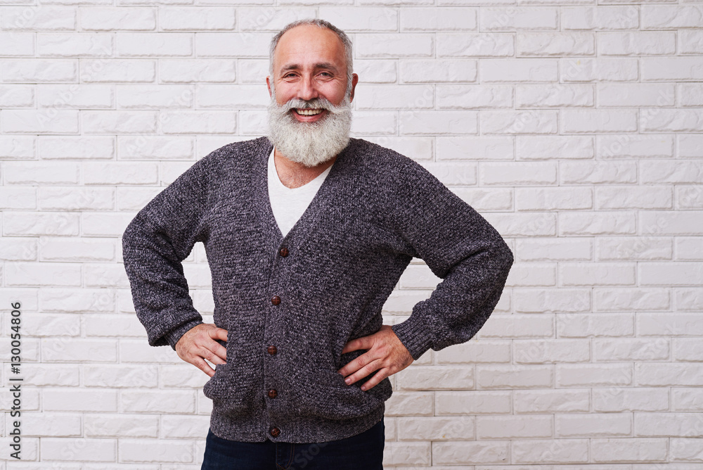 A cheerful grandpa standing against white background Stock Photo ...
