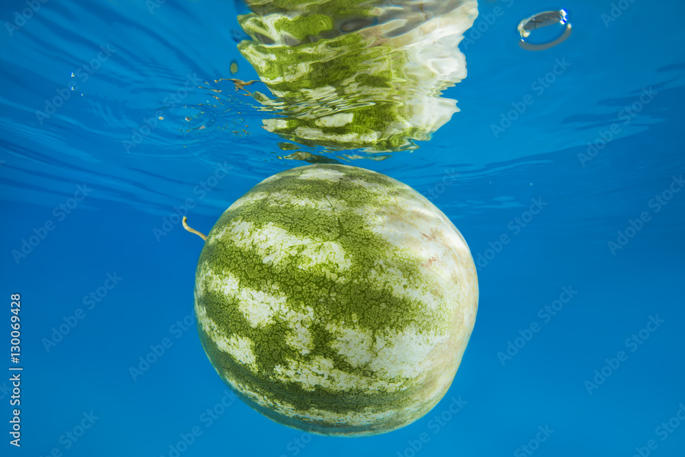 water-melon splashing in water on blue background Stock Photo | Adobe Stock
