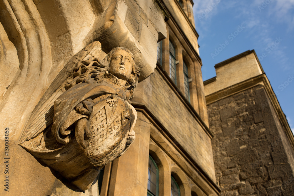 Medieval gothic sculpture representing an angel with long hair holding ...