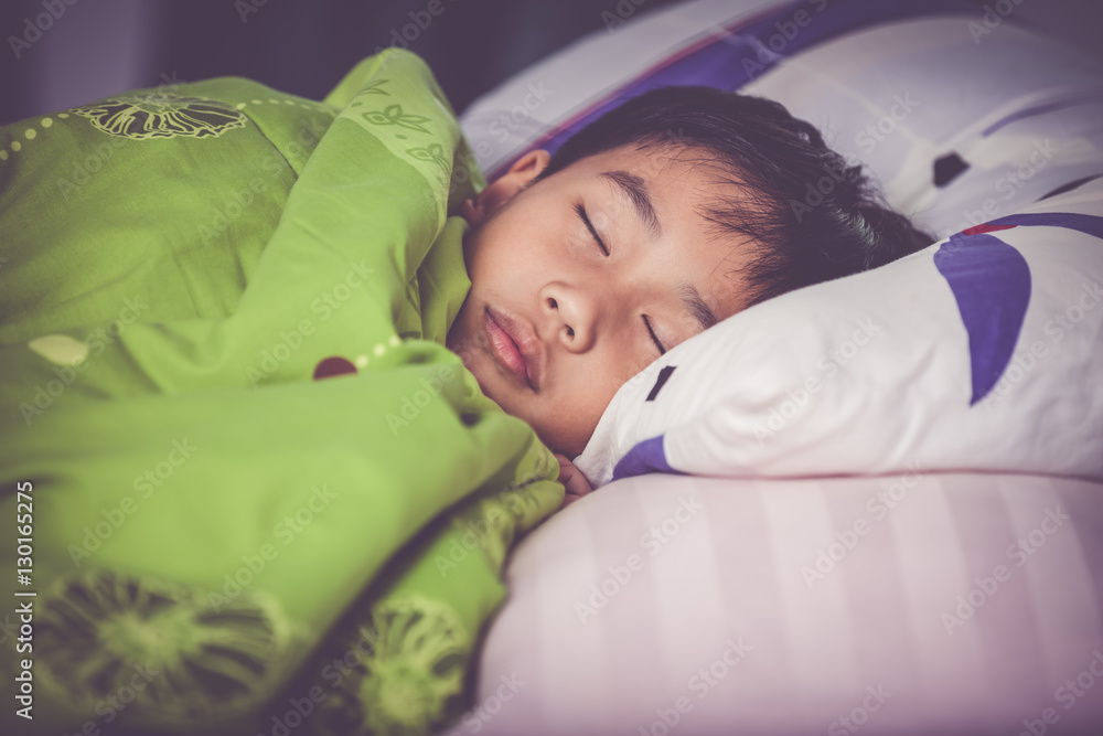 Healthy child. Little asian boy sleeping peacefully on bed. Vintage ...