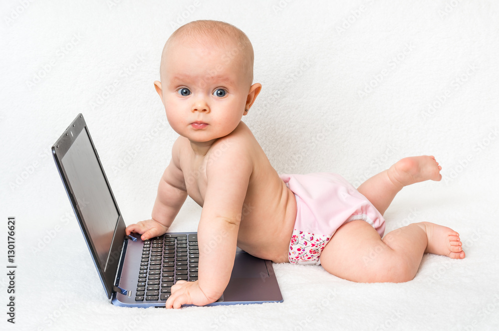 Cute baby girl in a diaper playing with laptop Stock Photo | Adobe Stock