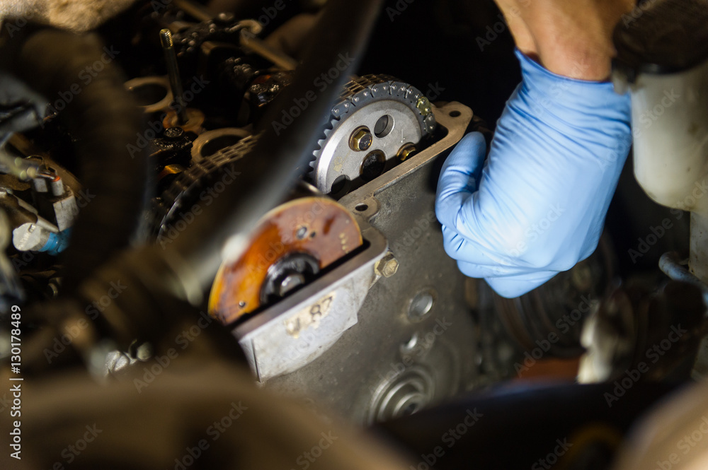 Mechanic fixing a car's engine Stock Photo | Adobe Stock
