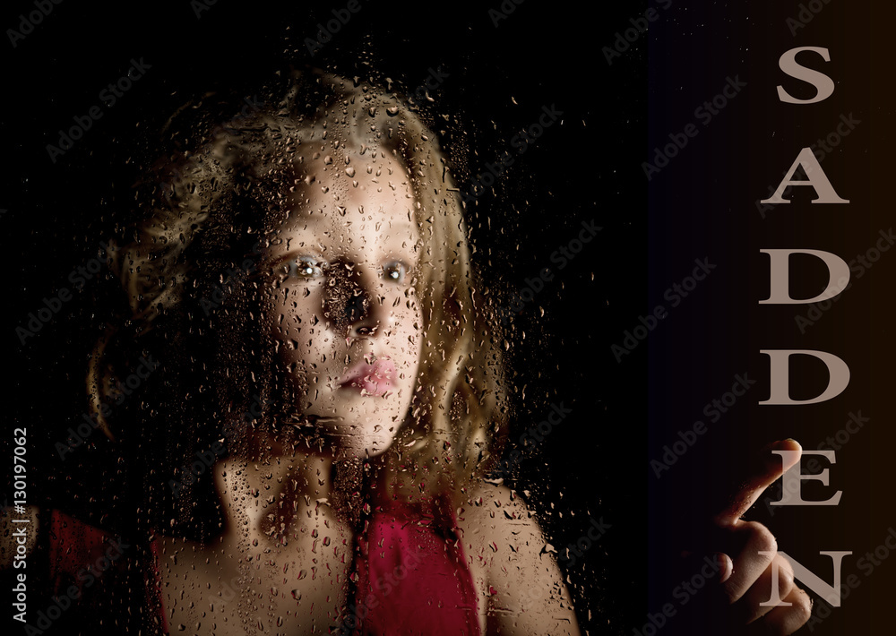 sadden written on virtual screen. hand of frightened young girl ...