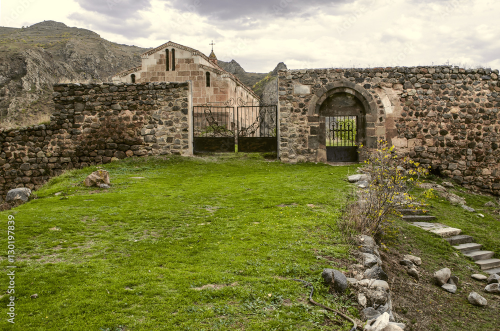 Gate and the front door in the stone wall built around medieval ...