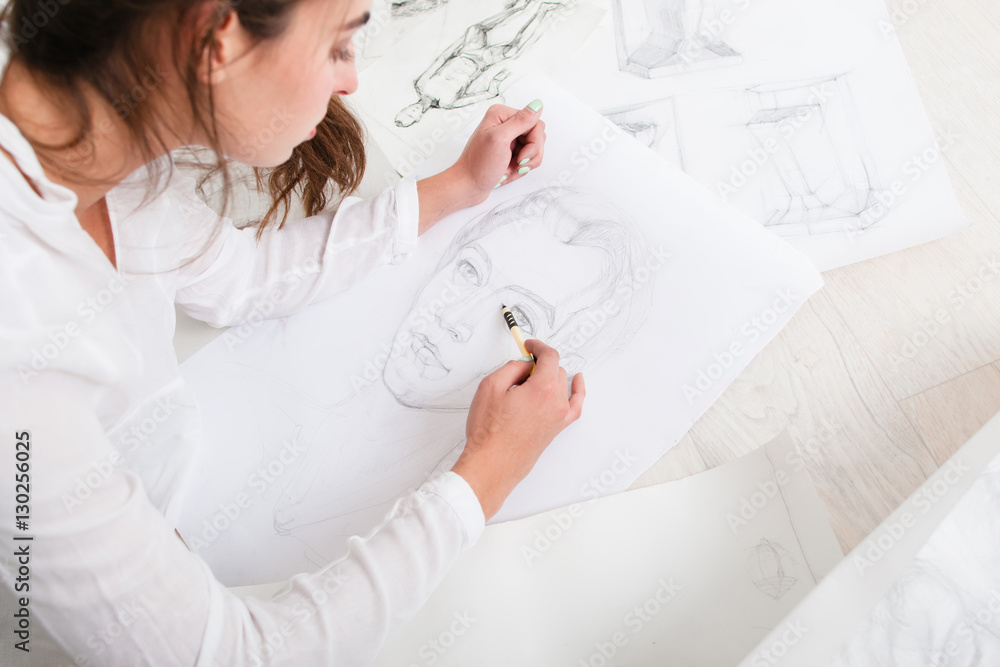 Artist finishing human pencil portrait on floor. top view on woman ...