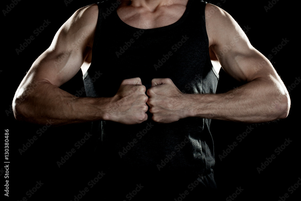 Male body-Builder with a strong hands, fists abut each other, stand ...
