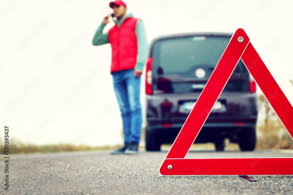 Traffic warning sign on road with car and driver on background Stock ...