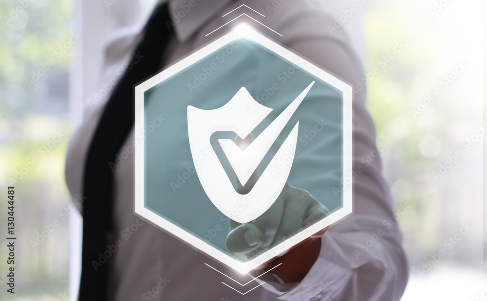 businessman presses shield button with a checkmark on virtual screens ...