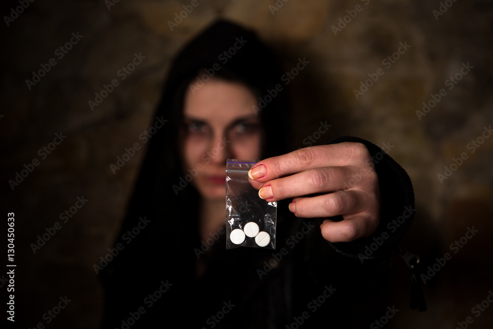 Drug addict demonstrating wheels, tablets with substance. Drug addict ...