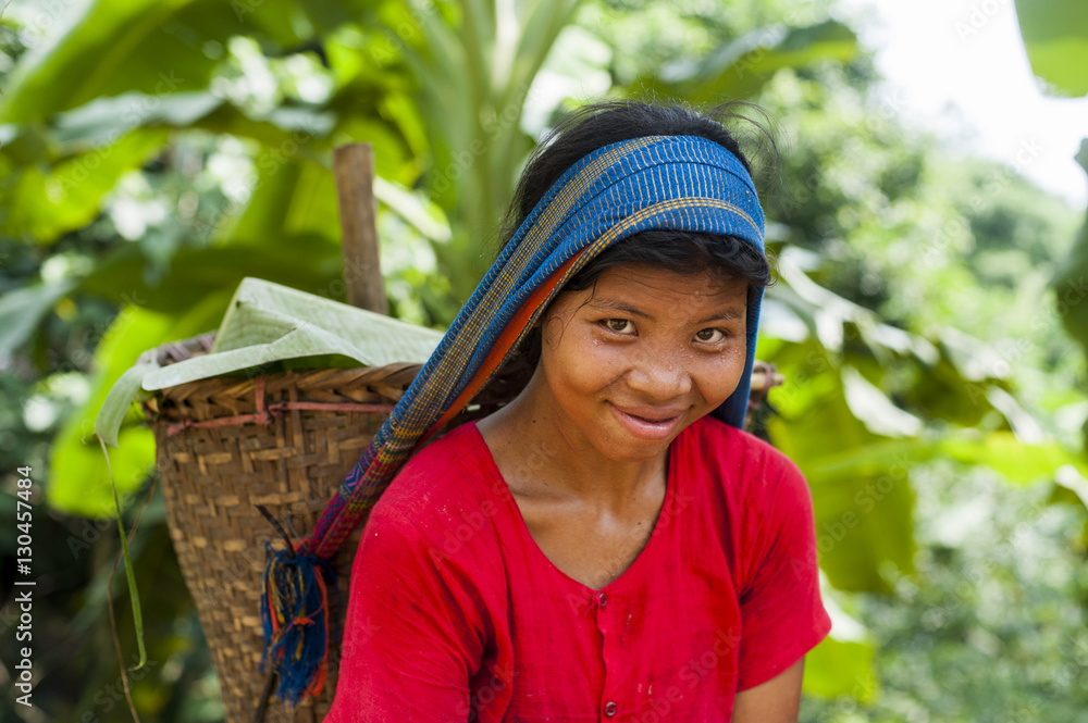 A Chakma girl in the Rangamati area in Bangladesh collects banana ...
