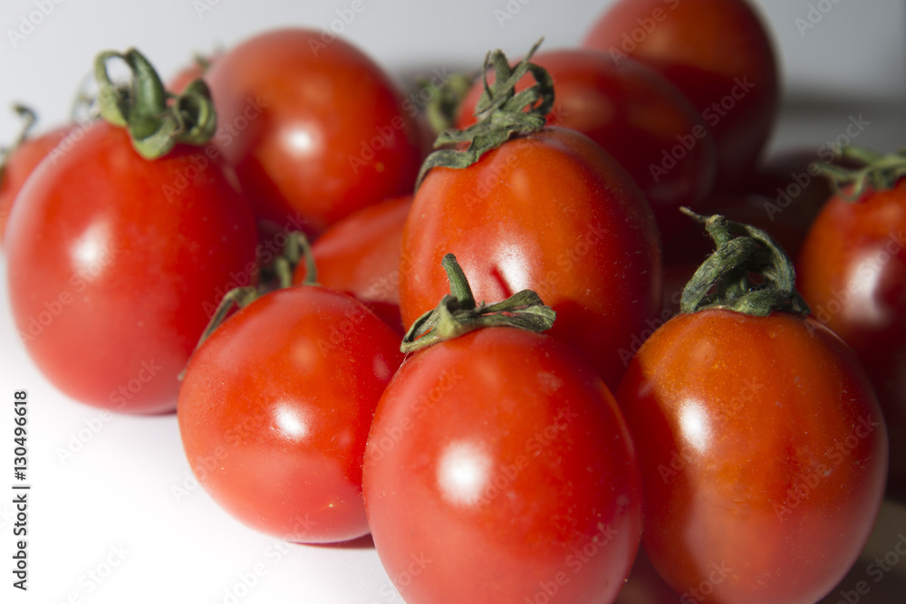 Red cherry tomatoes, photographed close-up. Stock Photo | Adobe Stock
